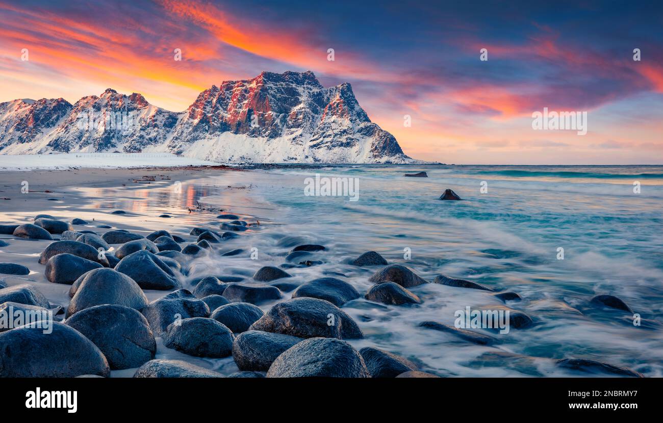 First sunlight glowing huge peak on Haukland Beach, Vastvagoy. Stunning ...