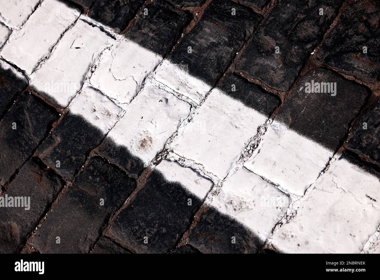 Road markings on the paving stones. The old road in the city. Historic ...