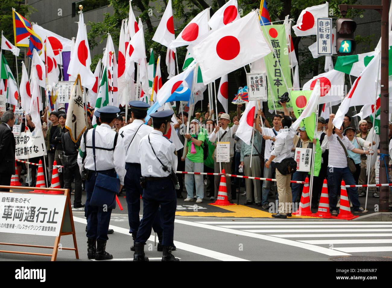 Protesters wave Japanese flags as they gather in front of the ...