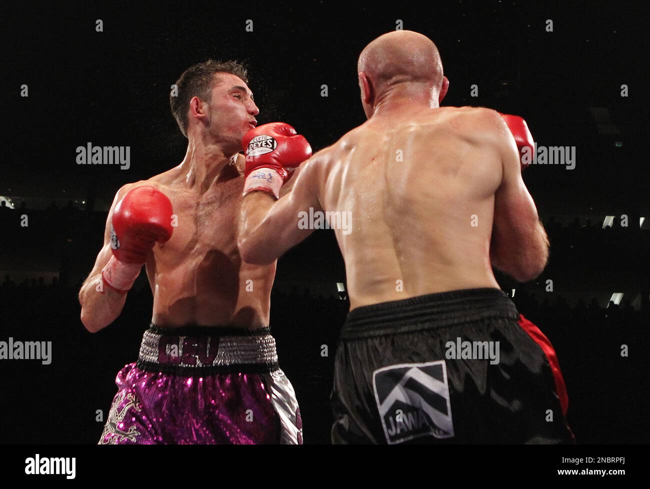 Britain's Nathan Cleverly, left , is hit by a punch from Poland's ...