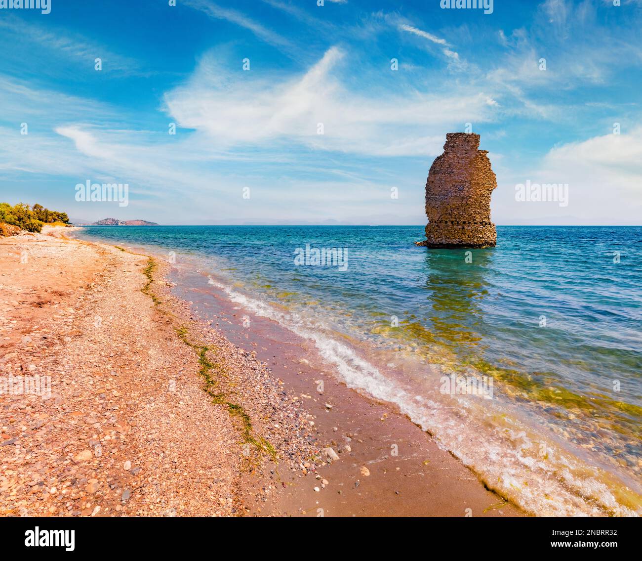 Empty Mylos Beach ruins of old Roman tower on background. Exotic summer ...