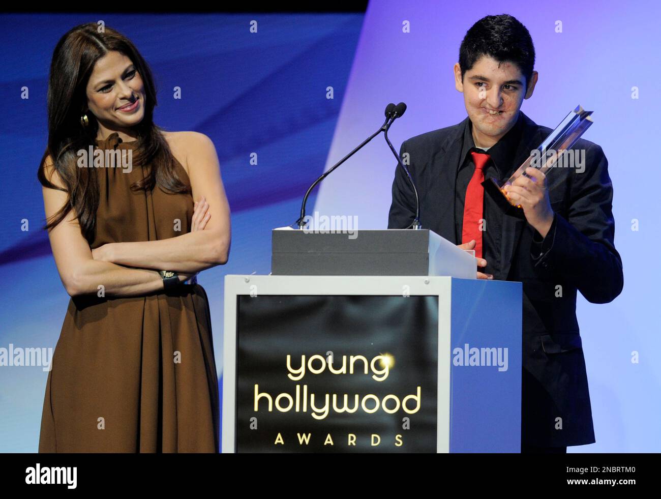 Presenter Eva Mendes, left, looks on as David Anguiano accepts the Art ...