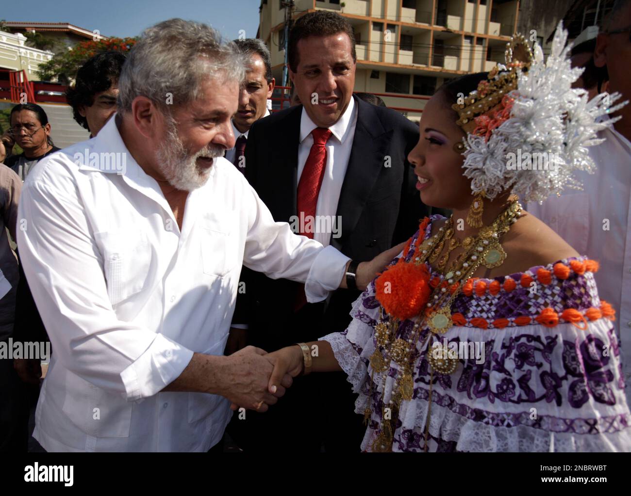 Brazil's former President Luiz Inacio Lula da Silva, left, shakes hands ...