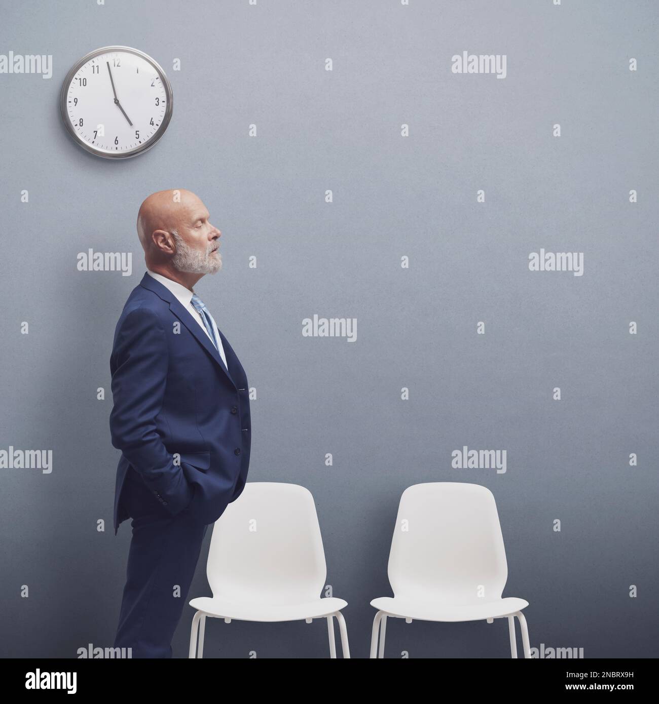 Corporate businessman standing in the waiting room, he is waiting for a ...