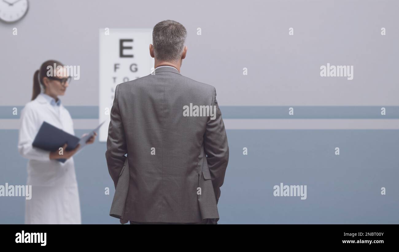 Patient having an eye exam and testing vision with a professional ...