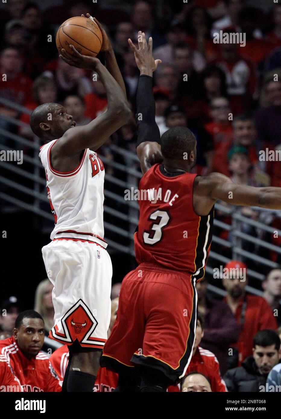 Chicago Bulls' Luol Deng, left, shoots against Miami Heat's Dwyane Wade ...