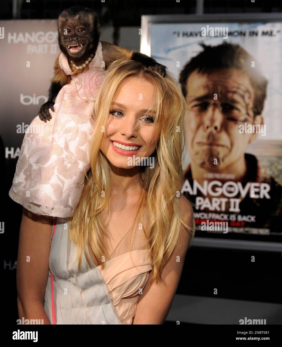 Actress Kristen Bell poses with "Crystal the Monkey," a cast member in "The Hangover Part II ...