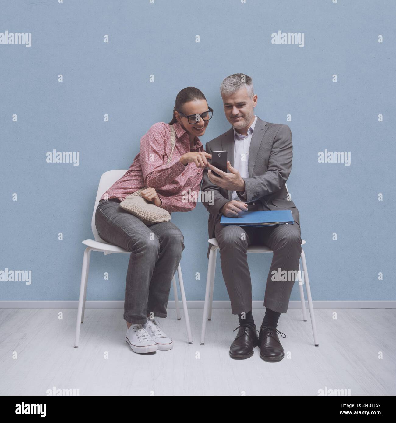 People waiting for an interview, they are sitting and watching a ...