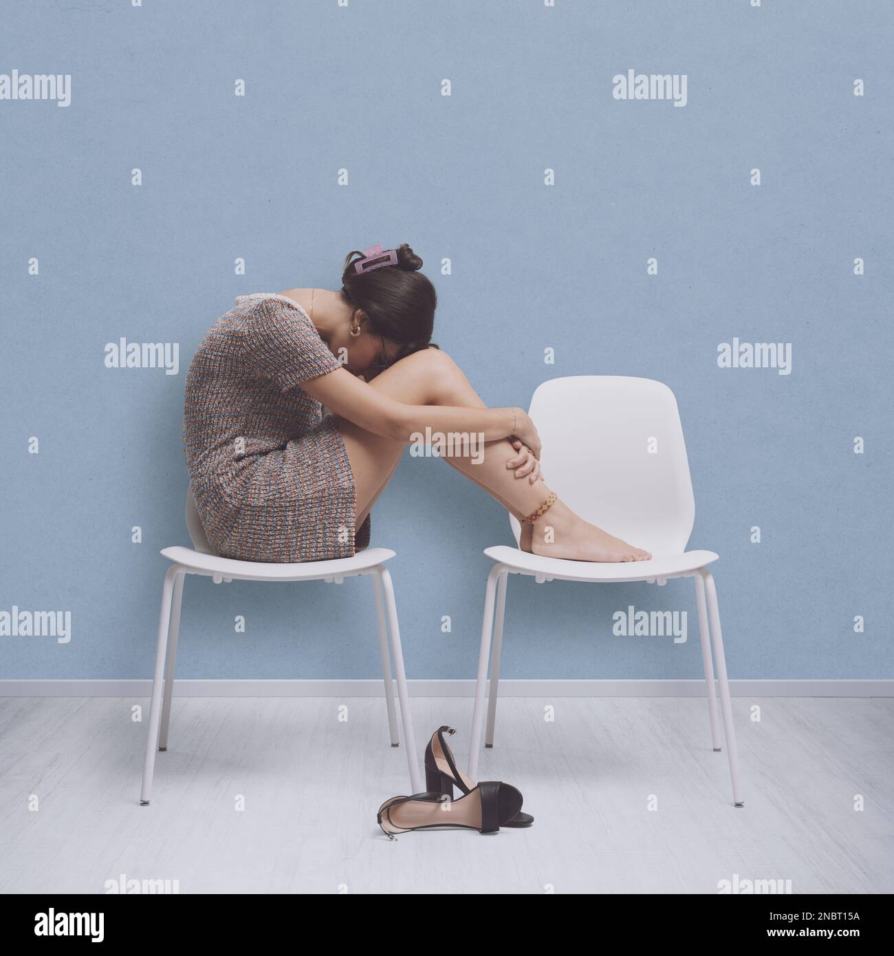 Exhausted young woman lying on chairs in the waiting room, she is ...