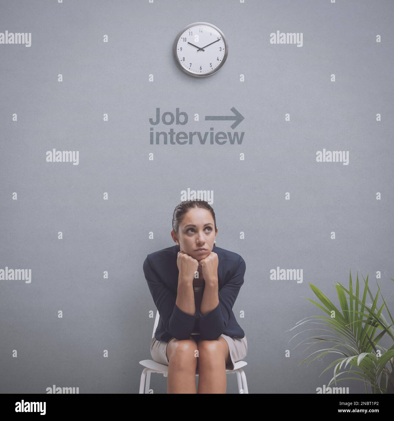 Bored young woman sitting on a chair and waiting for a job interview ...