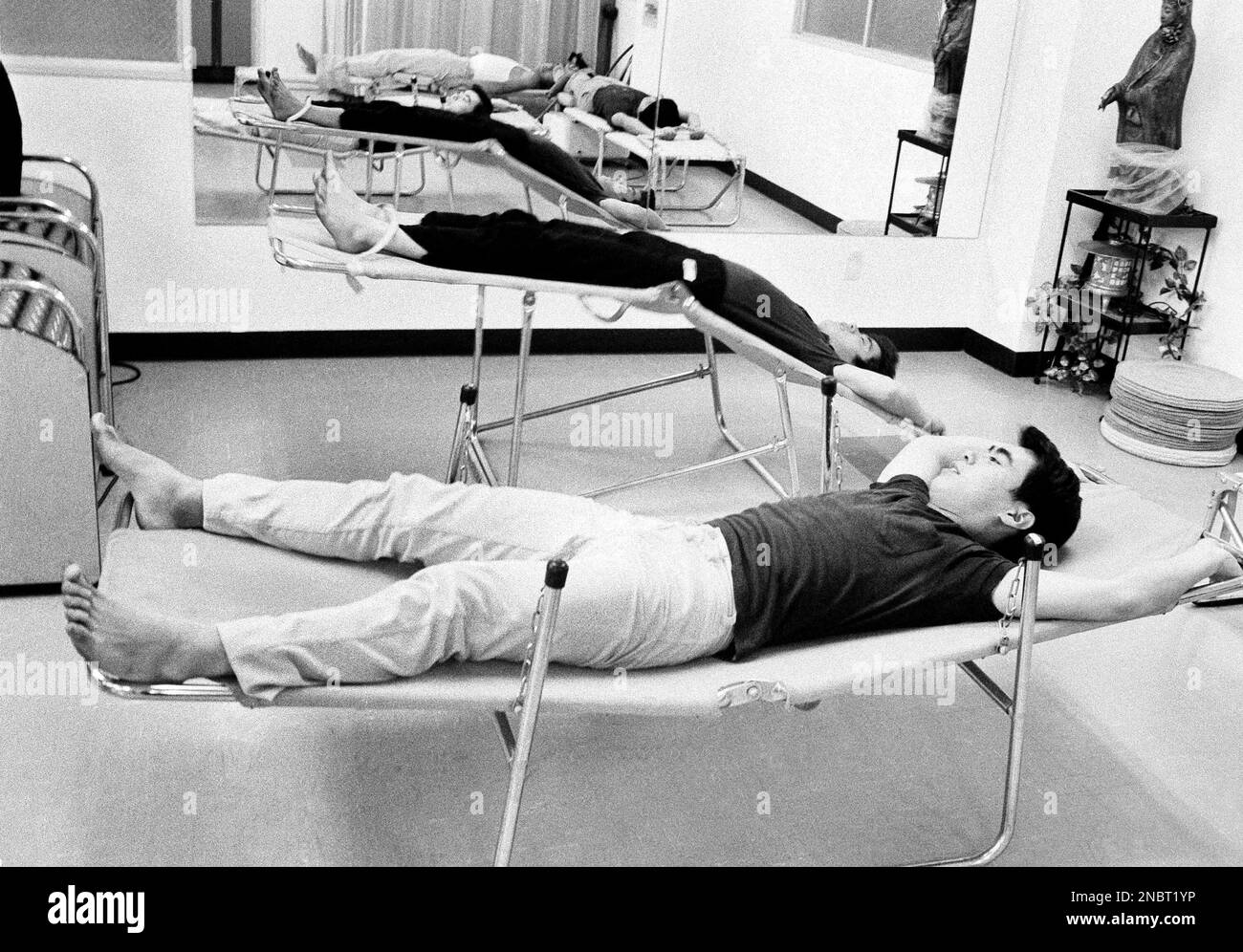 On what looks a bit like a torture rack, two men do stretching ...