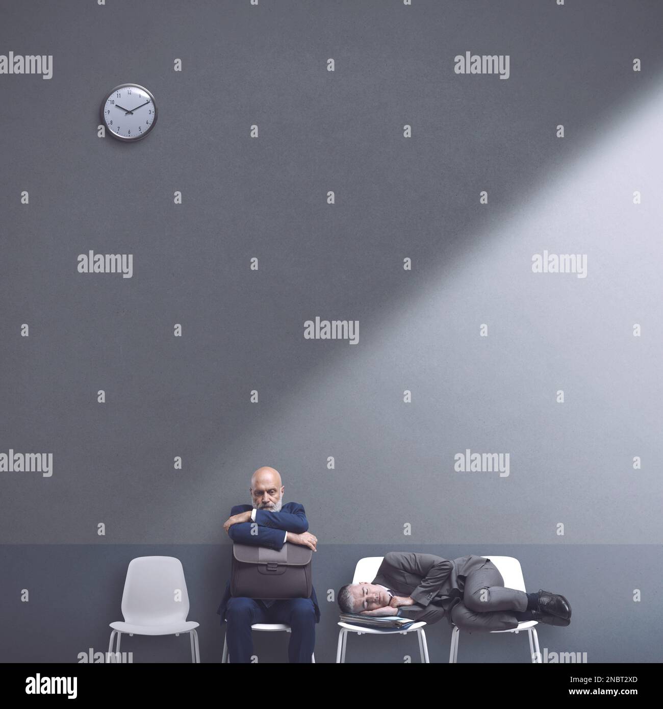 Tired people sitting and waiting in a corporate building late at night ...