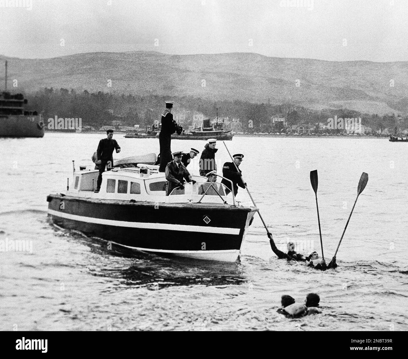 Pacifists, one holding cars aloft, are hauled to launch on Holy Loch ...