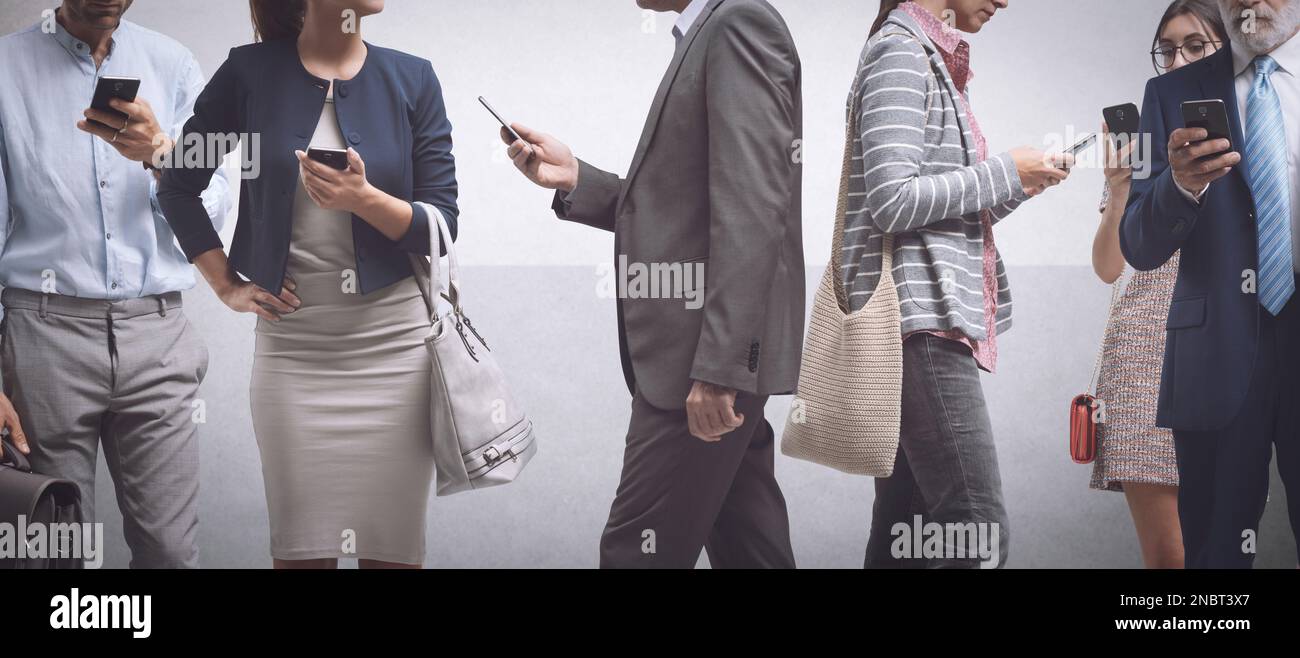Crowd of distracted people walking in the city street and using ...