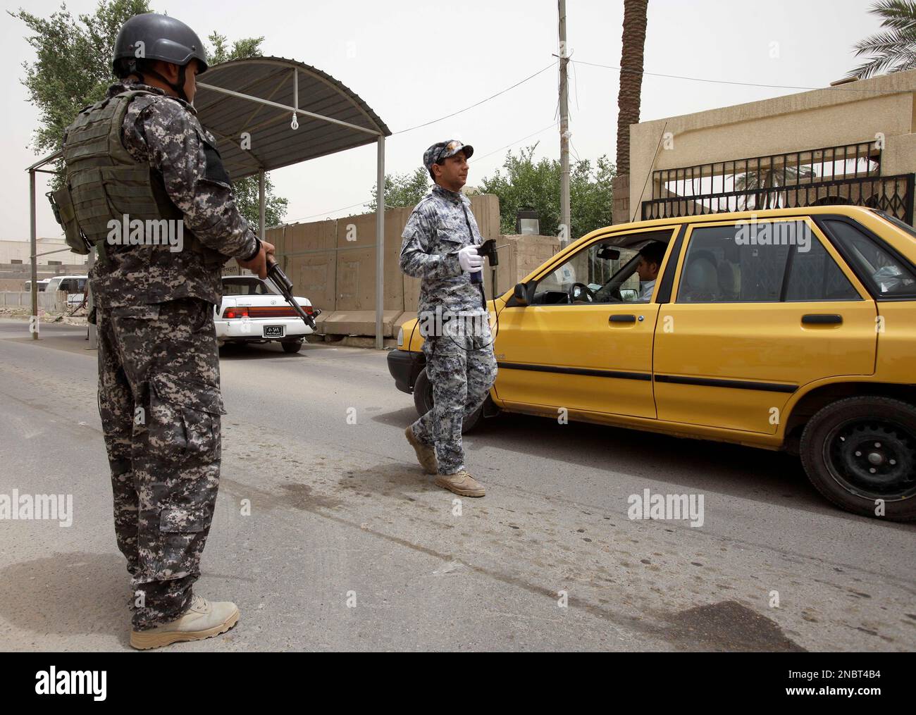 Iraqi policemen are seen at a checkpoint in central Baghdad, Iraq ...