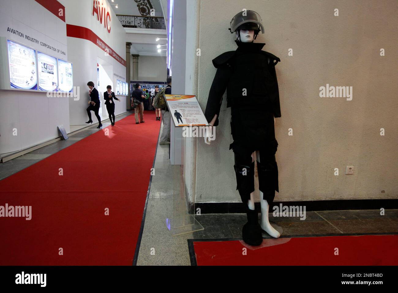 A mannequin dressed with anti-riot gear is displayed an exhibition of ...