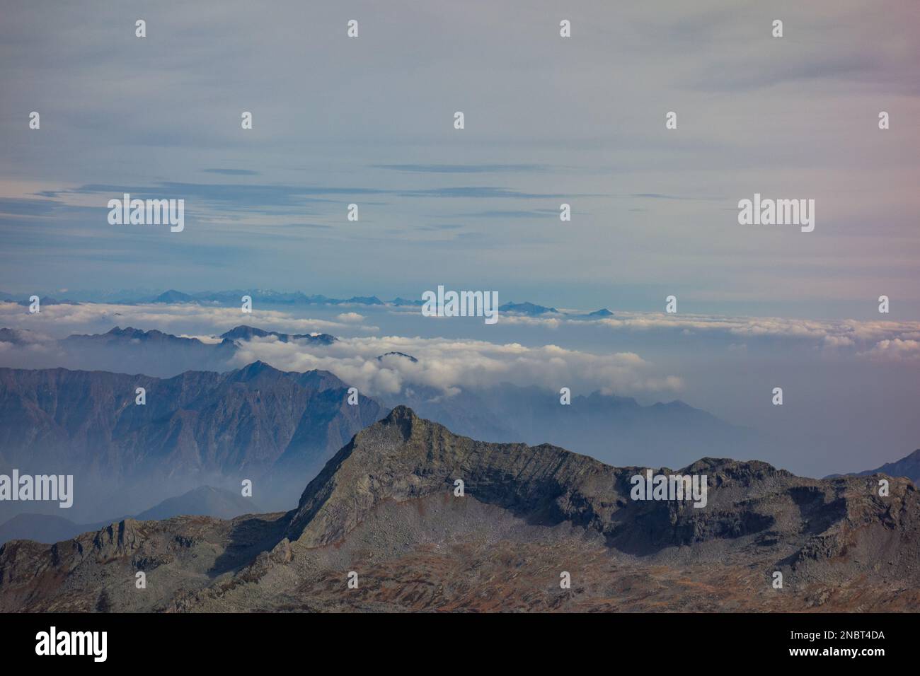 The Swiss Alps on a cloudy day against a blue sky, Switzerland Stock ...