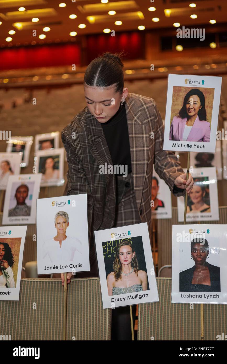 Publicist Jamey Rowsell places placards with the images of actors on ...