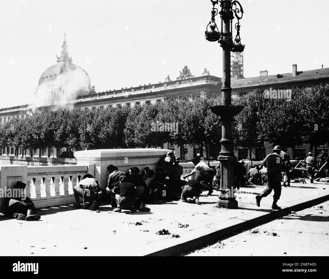 Maquis, French troops and civilians take cover and return the fire as ...