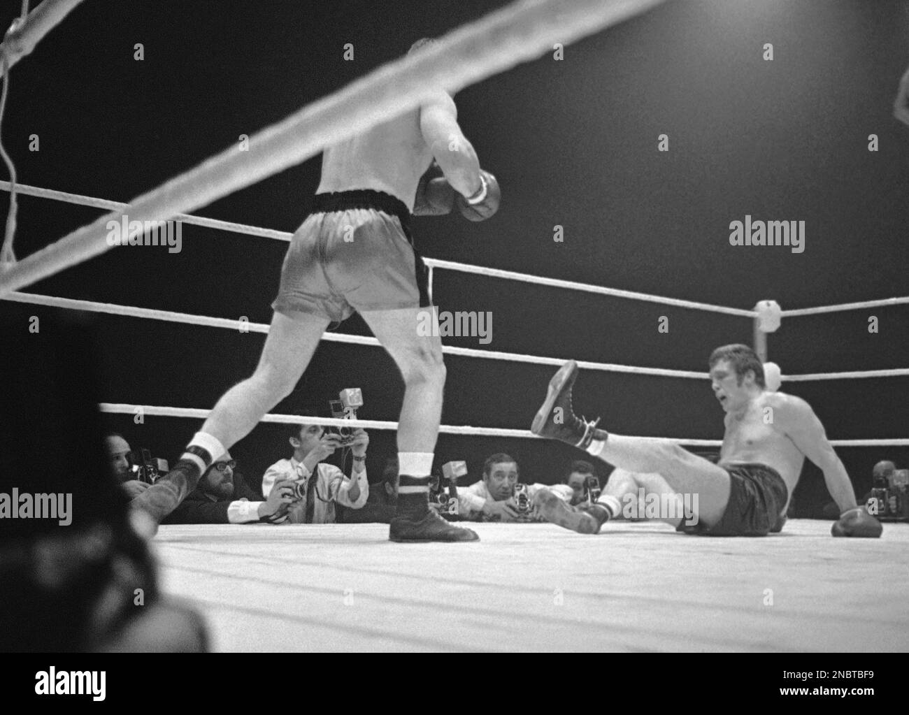 British Heavyweight Billy Walker is dumped onto the canvas in round one ...