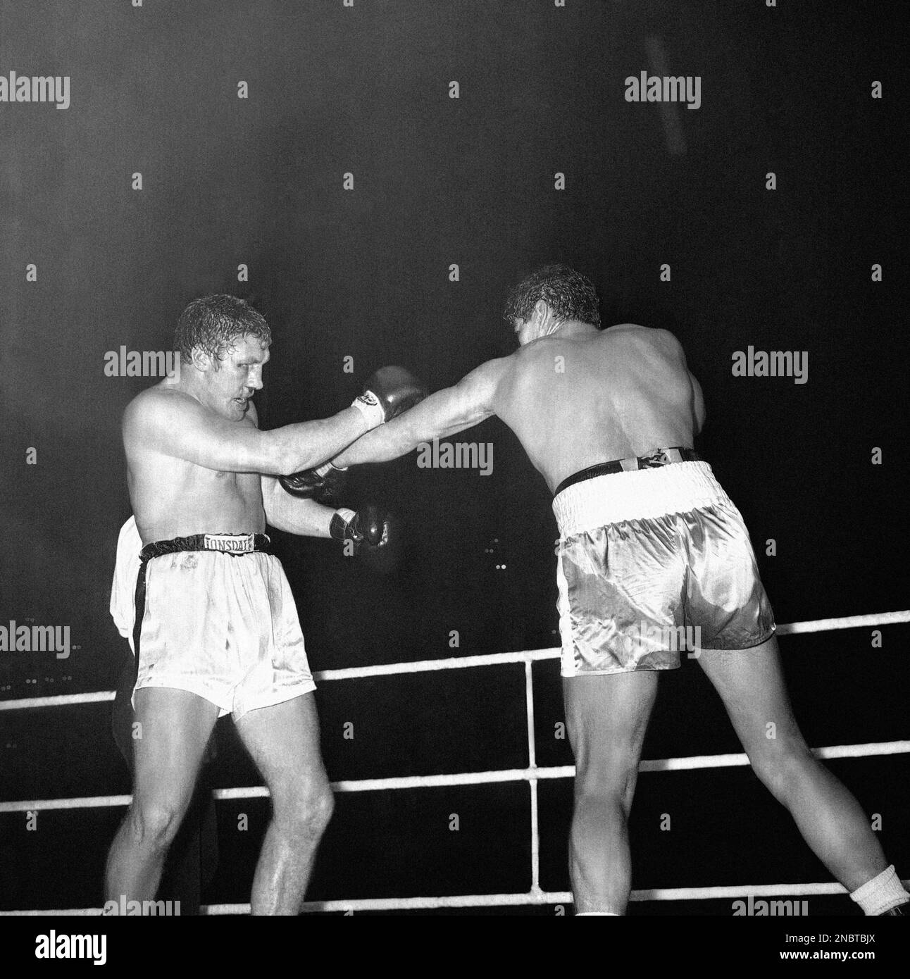 London heavyweight Billy Walker, left, fends off a left from ...