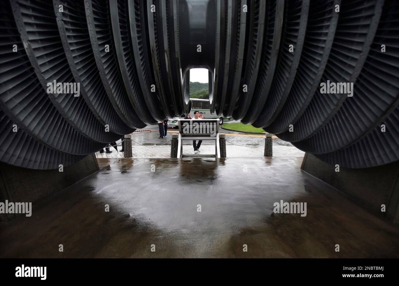 A visitor stands behind a massive low pressure turbine rotor at the ...