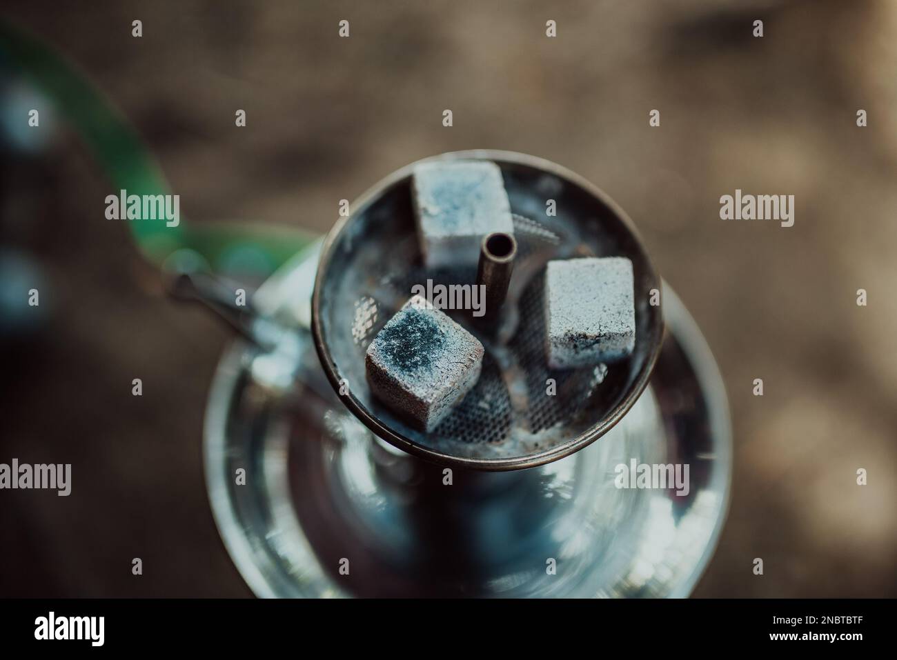 Shisha hookah with red hot coals. Sparks from breathe. Toned image ...