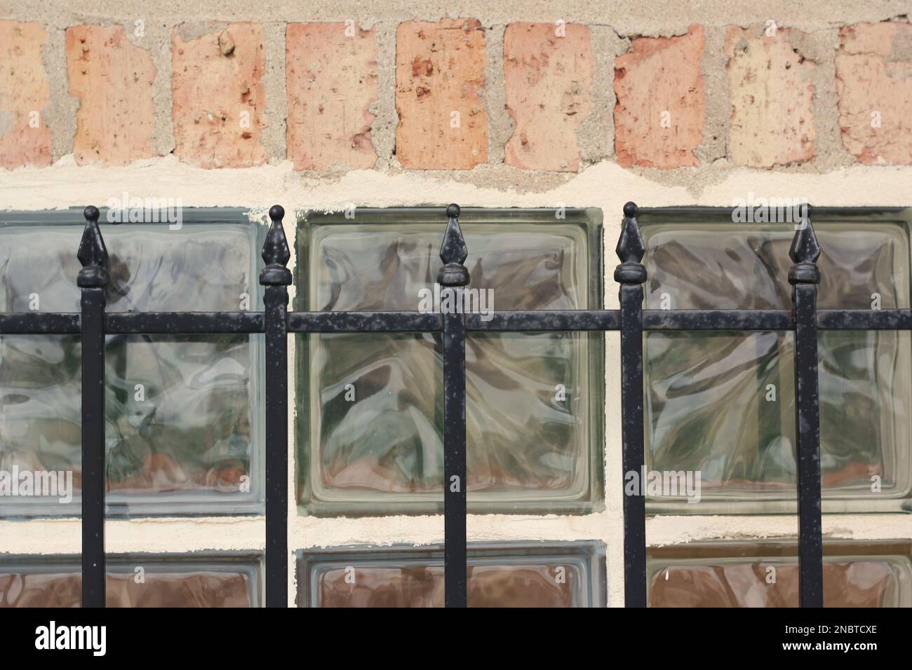 Traditional decorative wrought iron security fence guarding a glass ...
