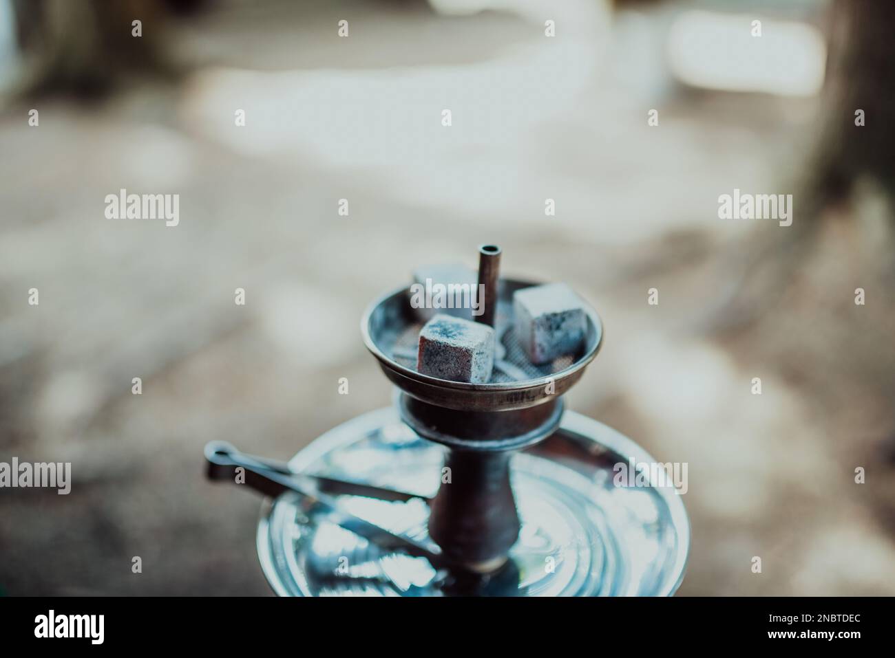 Shisha hookah with red hot coals. Sparks from breathe. Toned image ...