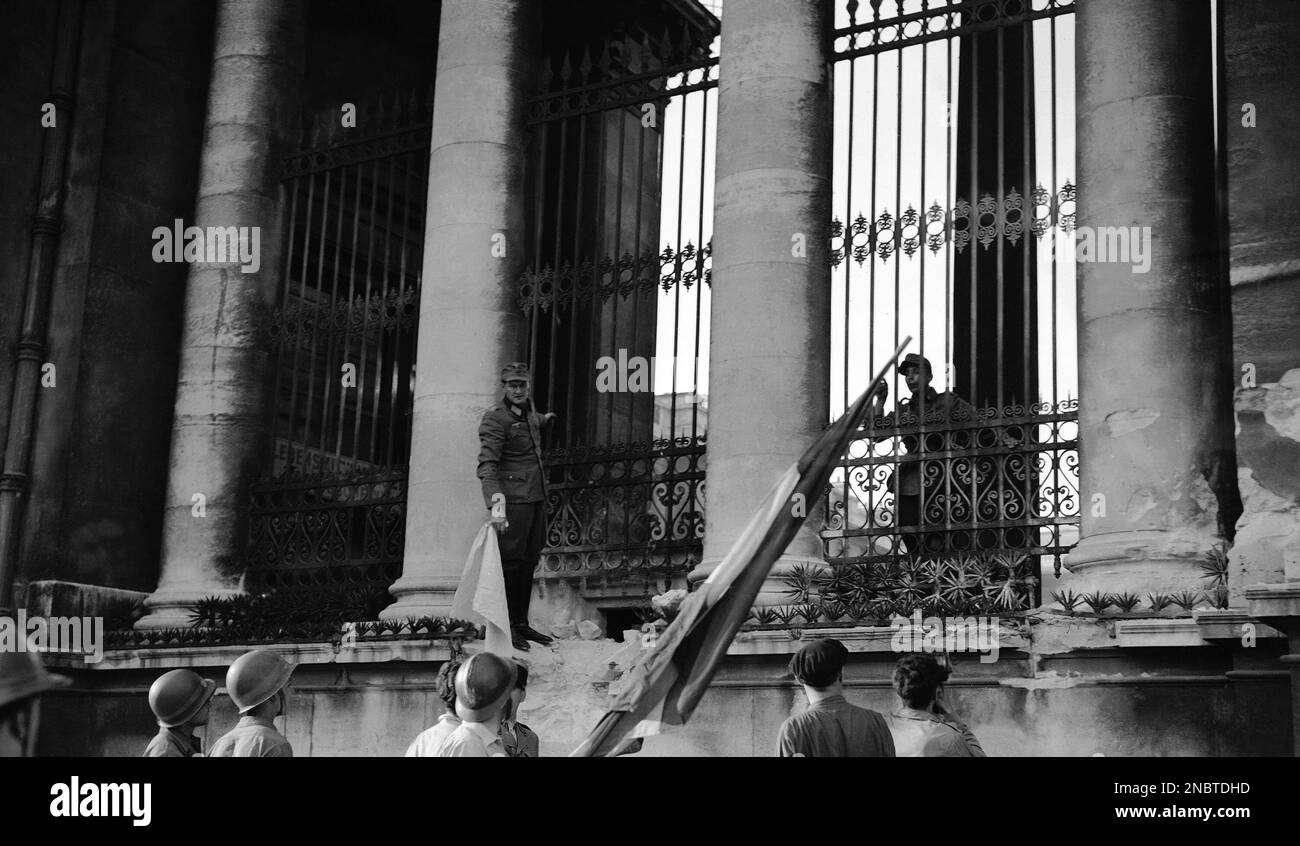 A German officer standing beside one of the columns of the Chamber of ...
