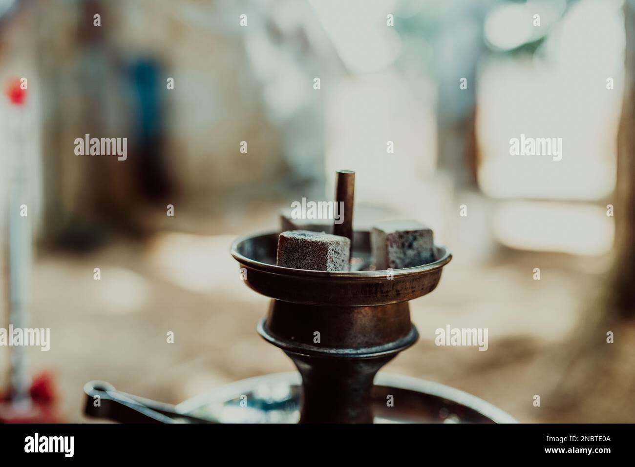 Shisha hookah with red hot coals. Sparks from breathe. Toned image ...