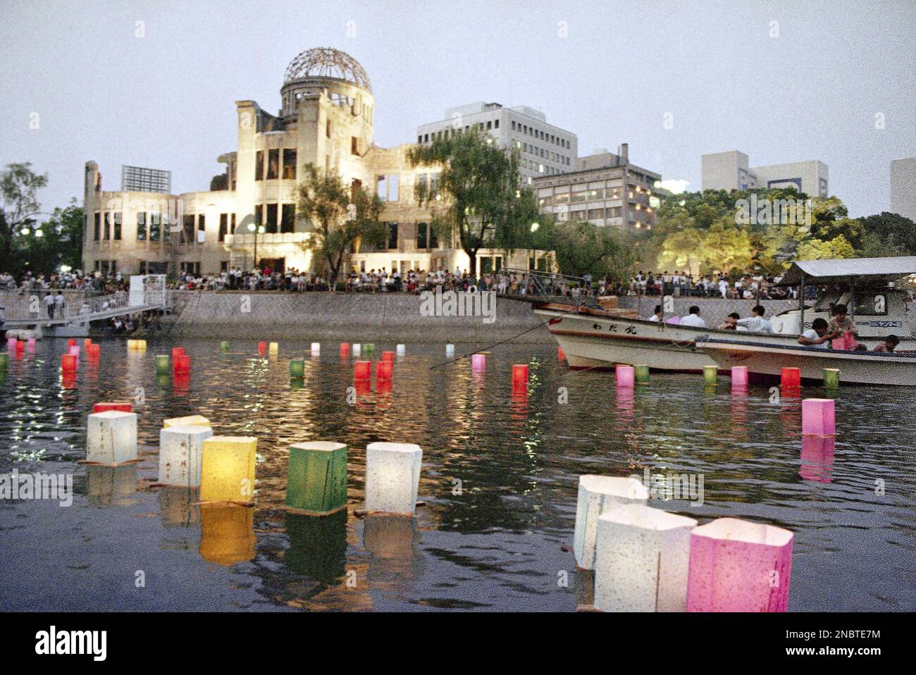 Paper lanterns float before the Atomic Bomb Dome on the Motoyasu River ...