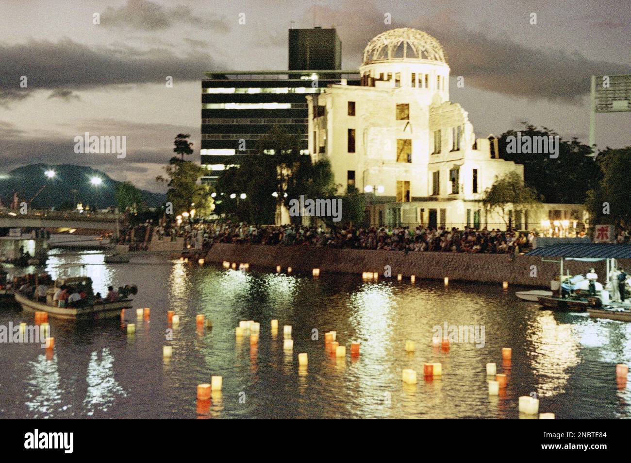 Paper lanterns float before the Atomic Bomb Dome down the Motoyesu ...