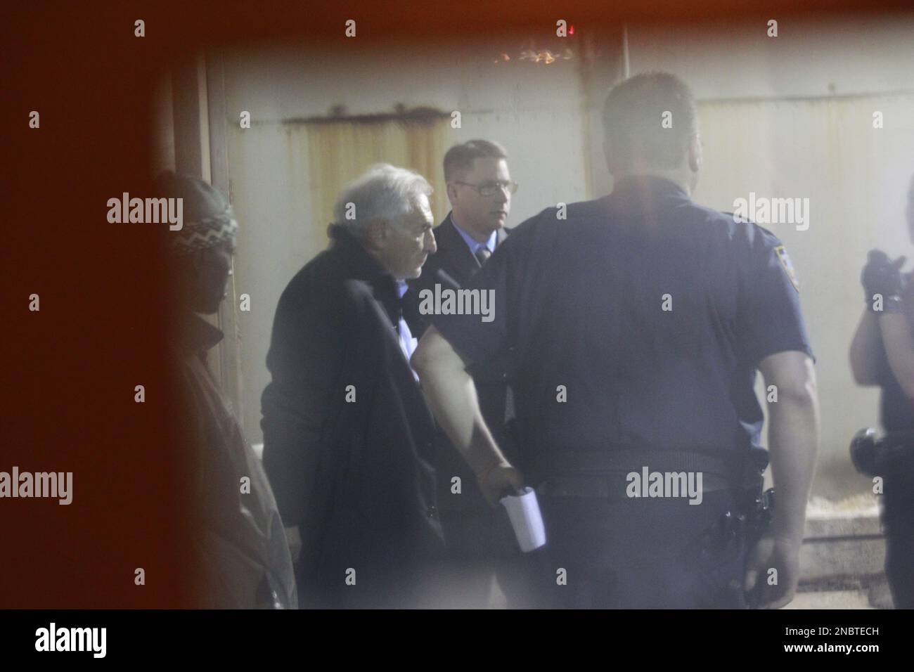 International Monetary Fund leader Dominique Strauss-Kahn is led into ...