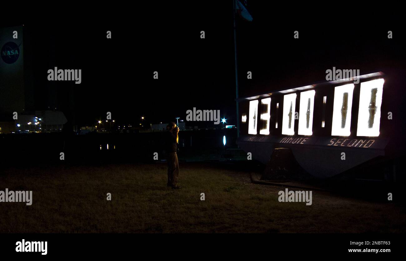 A photographer takes a picture of the countdown clock before the space ...