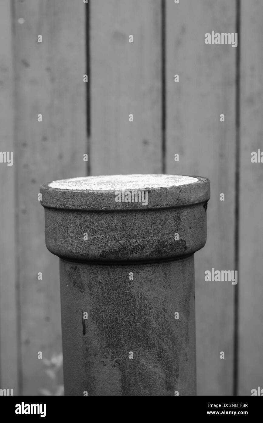 Solid steel post standing in the fields in a black and white Stock ...