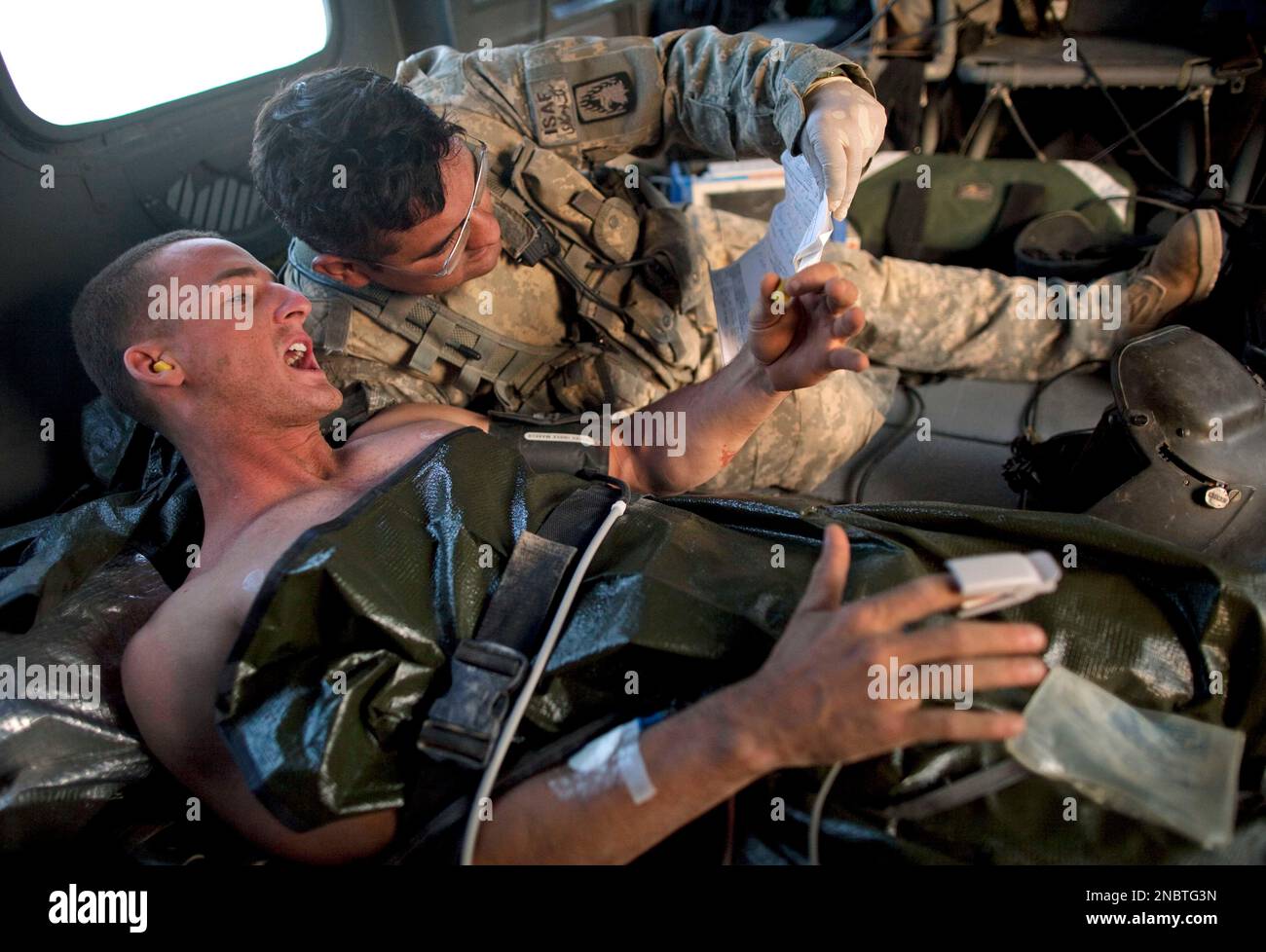 US Army flight medic SGT Jaime Adame, right, listens as United States ...