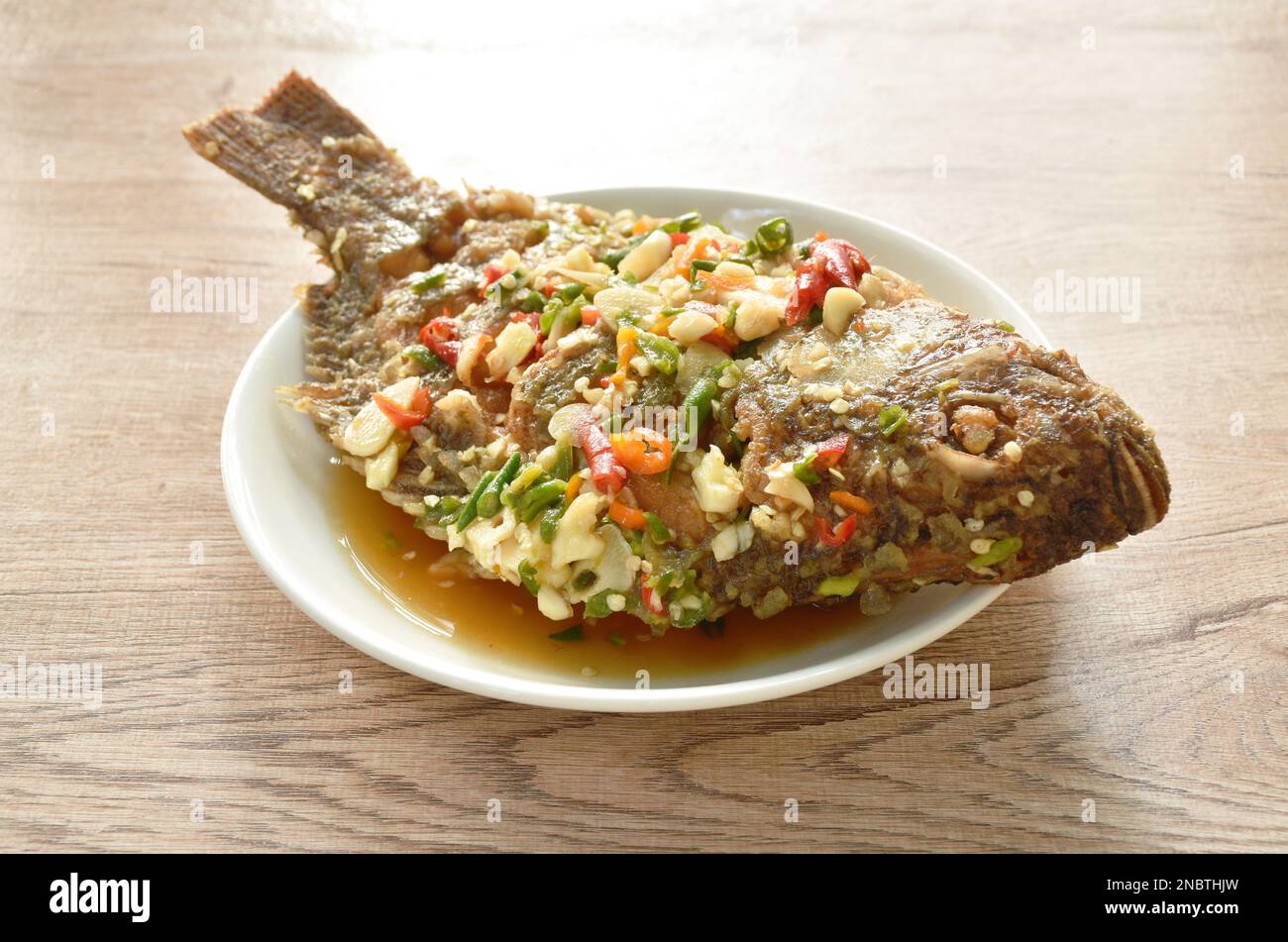 fried mango fish dressing spicy sauce herb sauce on plate Stock Photo ...