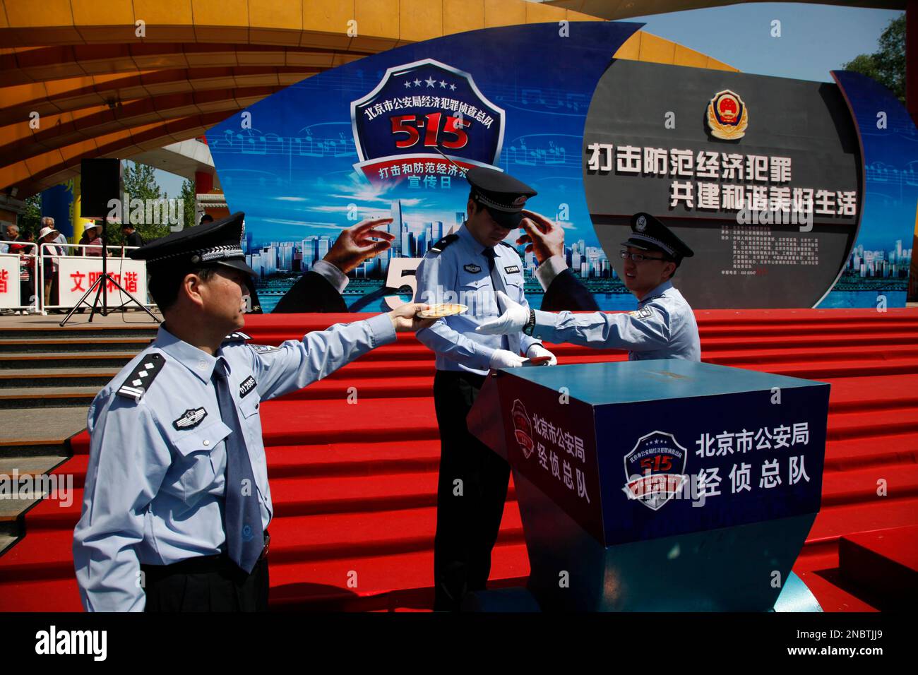 Chinese police officers prepare to destroy pirated DVDs during an event ...