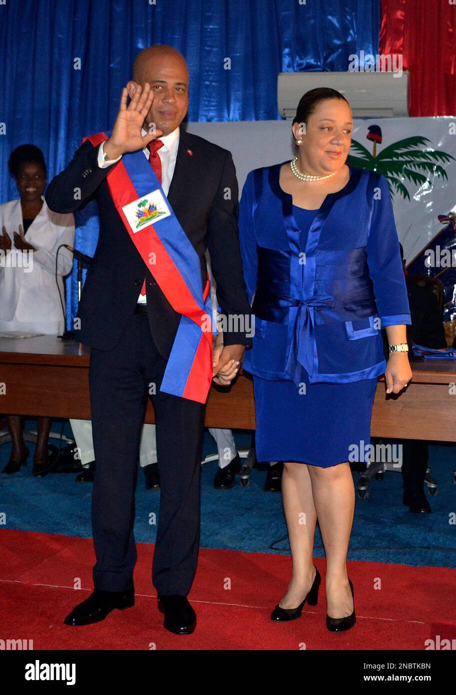 Michel Martelly, left, accompanied by his wife Sophia, waves after ...