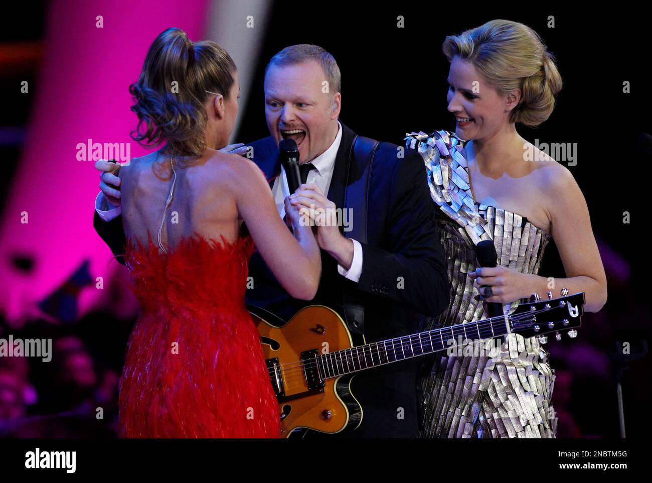 Presenters Anke Engelke, Stefan Raab and Judith Rakers, from left, sing ...