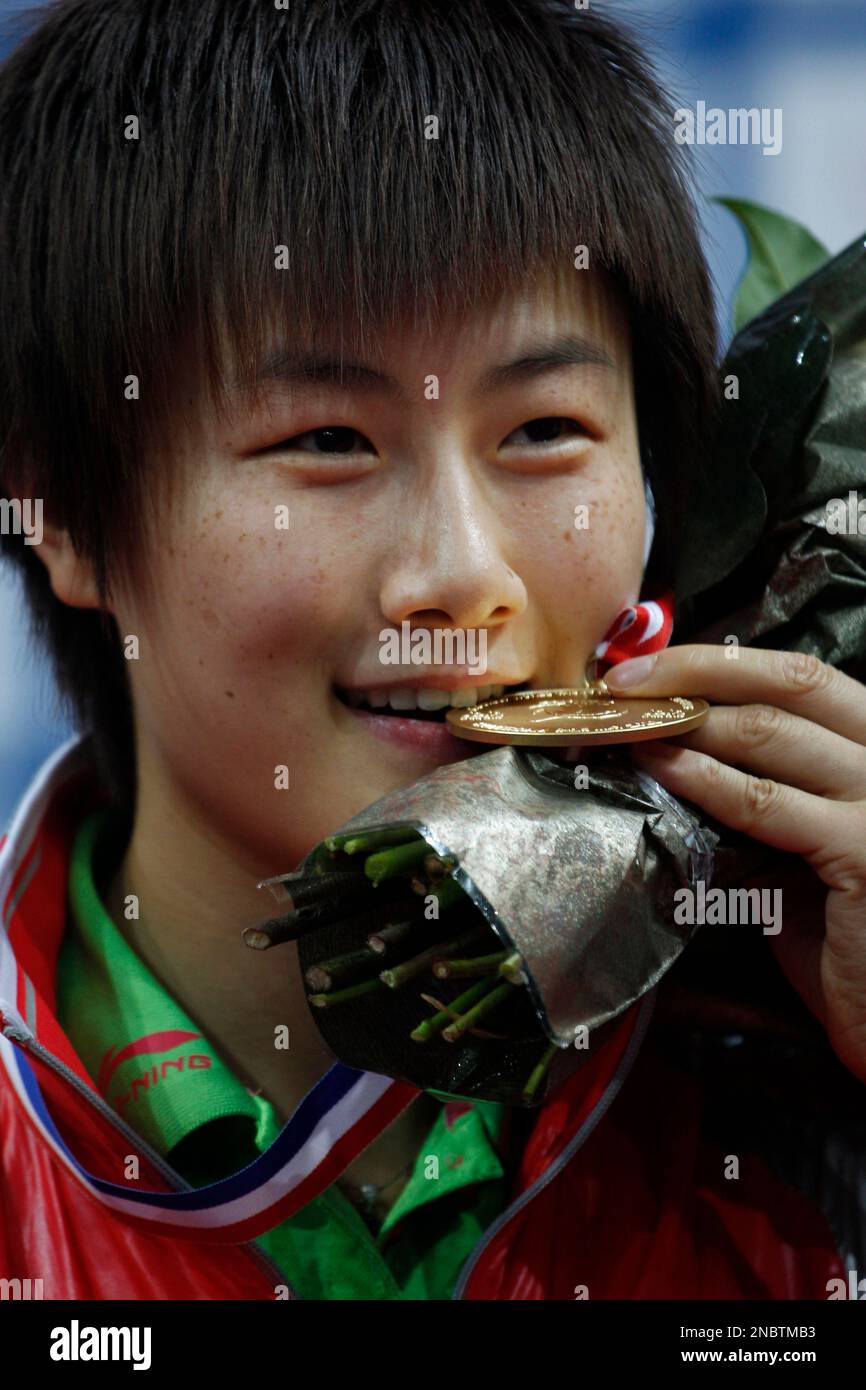 World champion Ding Ning of China holds her gold medal on the podium of ...
