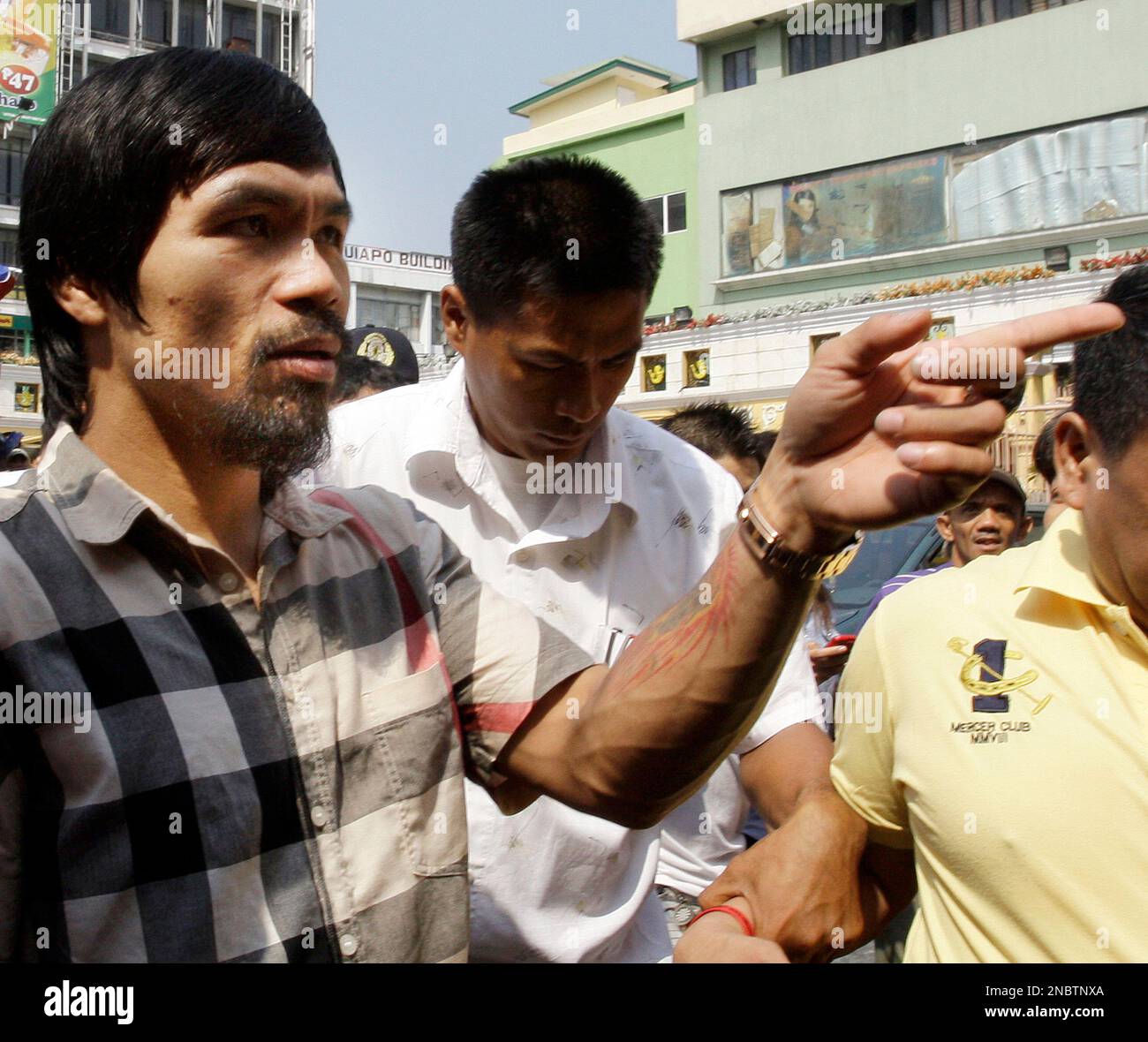 Filipino boxing champion Manny Pacquiao, left, gestures as he move ...