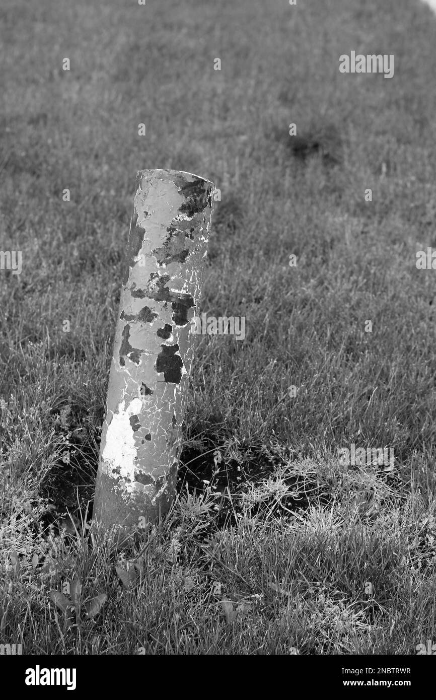 Solid steel post standing in the fields in a black and white Stock ...
