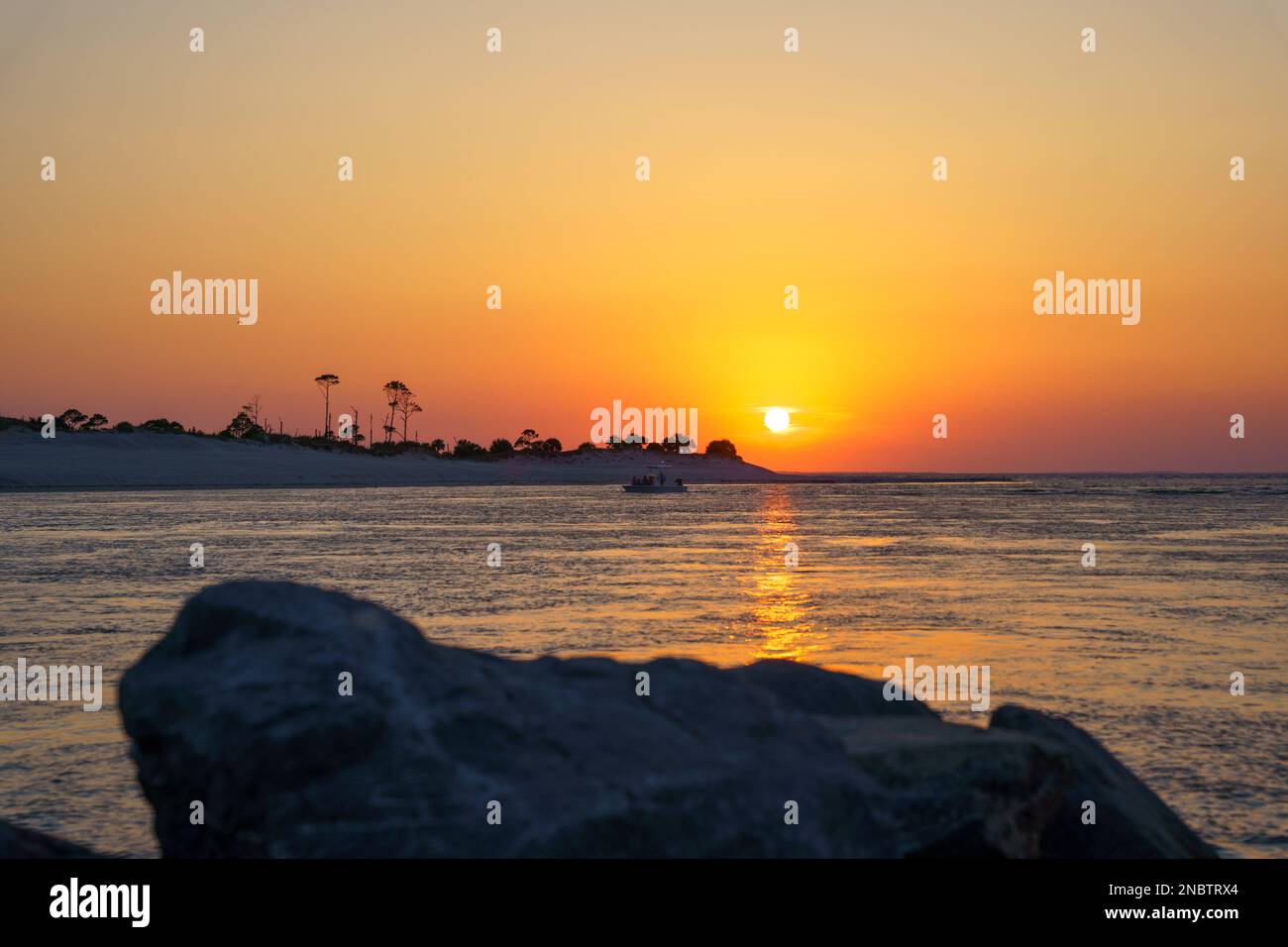 A breathtaking view of bright sky in orange sunset sky above the ocean ...