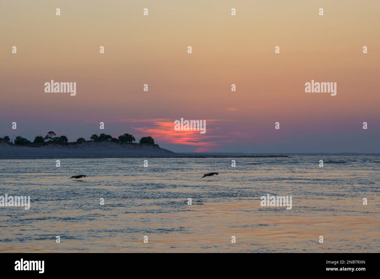 A breathtaking view of pink sunset sky and Saint George Island in ...