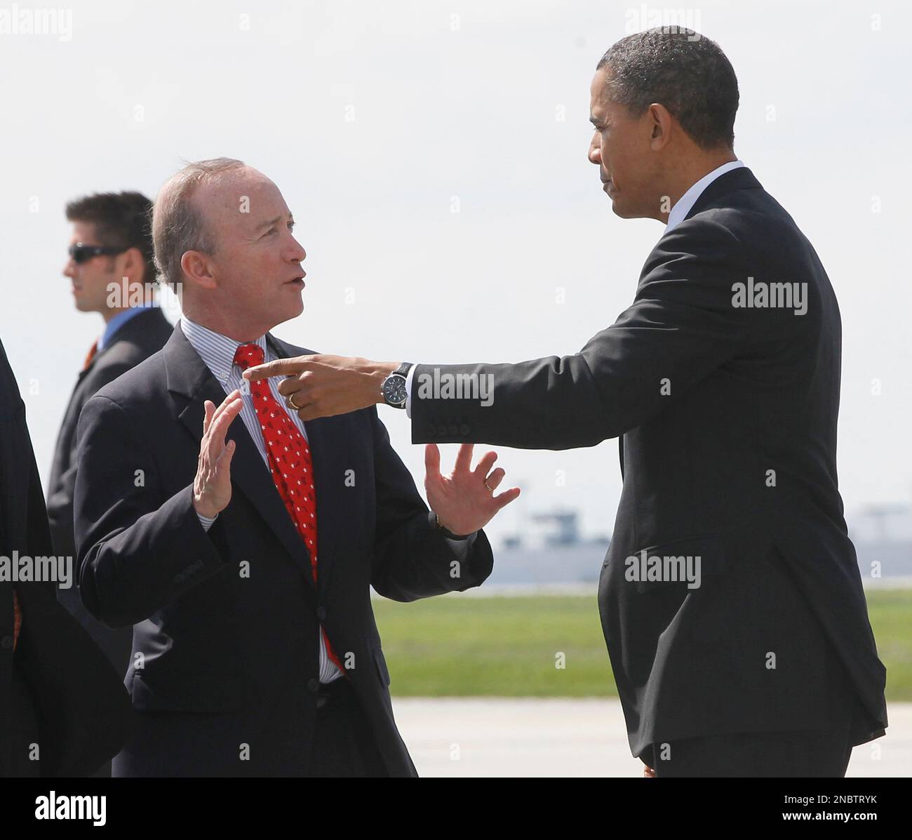 President Barack Obama is greeted by Indiana Gov. Mitch Daniels as he ...