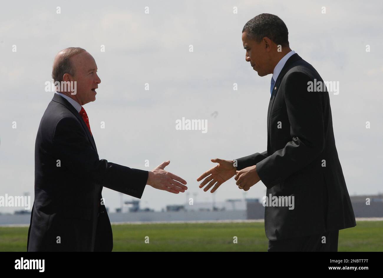 President Barack Obama is greeted by Indiana Gov. Mitch Daniels as he ...