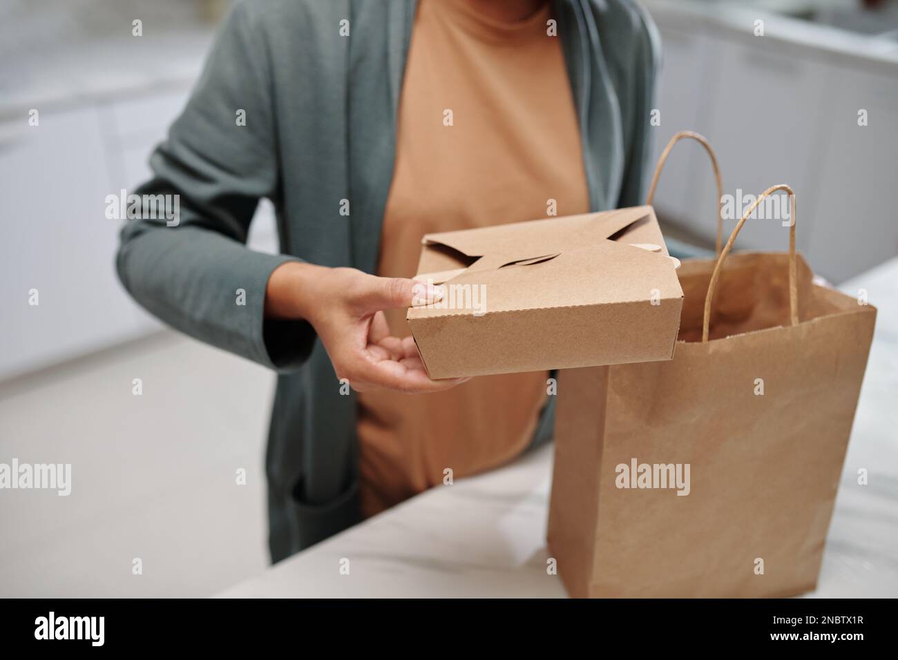 Hands of woman taking boxes with food out of paper package Stock Photo ...