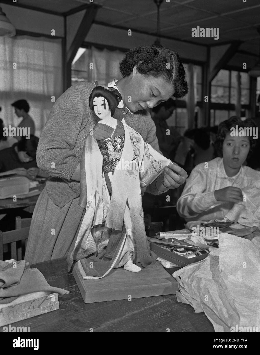 Next comes the dressing of the doll. An instructress, right, at the ...